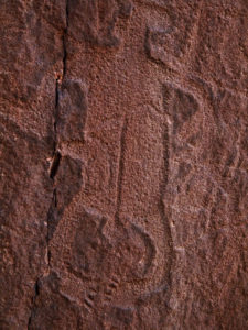 Bow-legged human at Shuwaymis - Arabian Rock Art Heritage